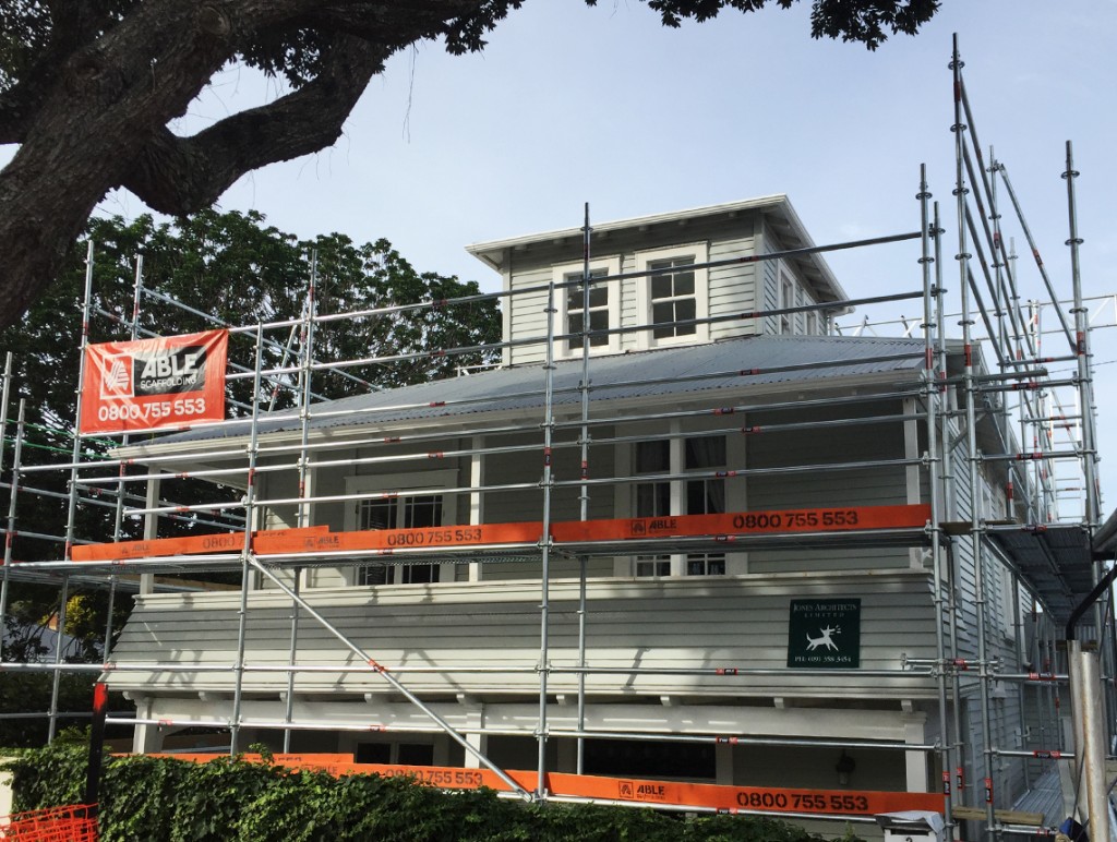 Builders extend this large home, on a tight and steeply sloping site ...